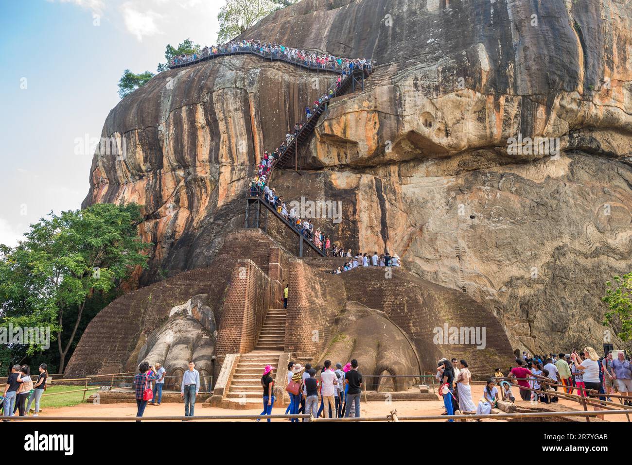 Big paws at the lions gate of the Sigiriya rock fortress. Pedestrians ...