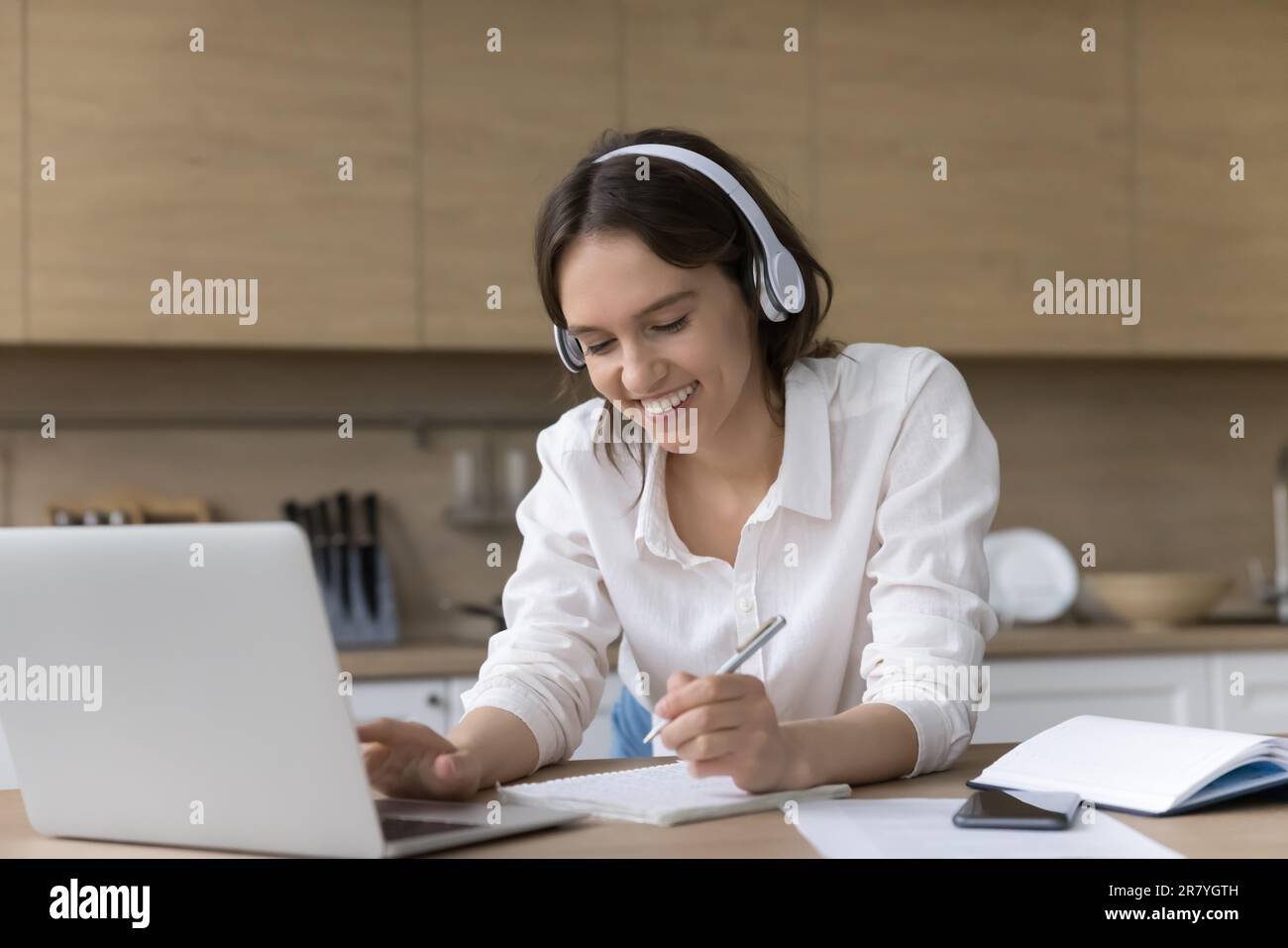 Happy beautiful lady enjoys remote learning on computer Stock Photo - Alamy