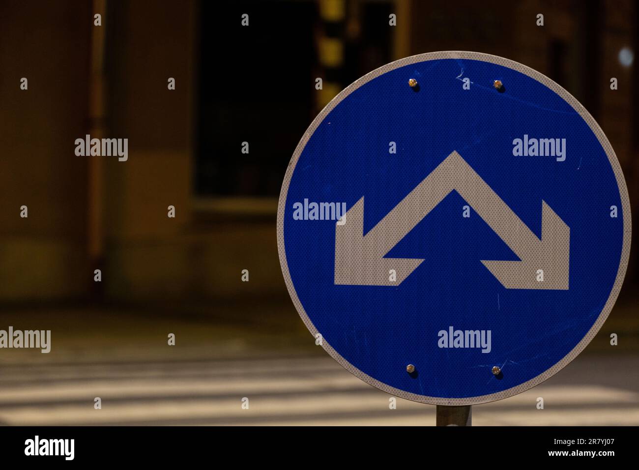 A closeup of a double turn road sign with a blurry background Stock ...