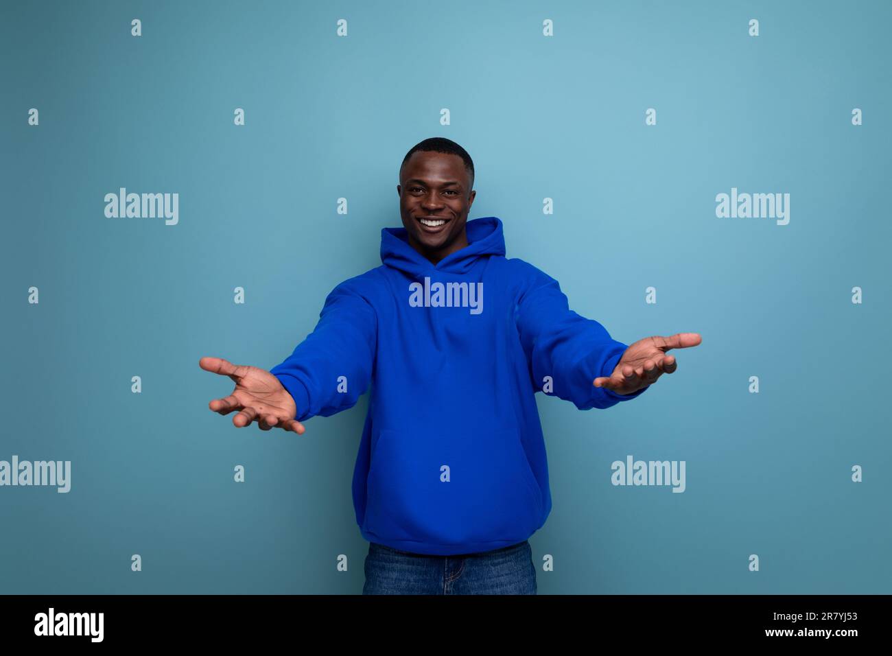young black american man in casual wear with open arms on studio ...