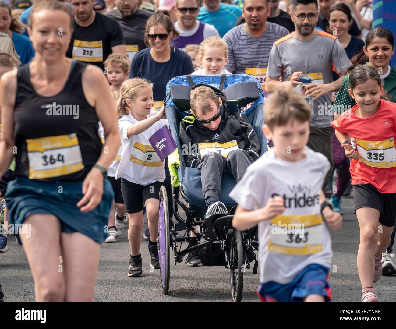 Rob Burrow is pushed by his daughters, Maya (left), 8, and Macy (right ...