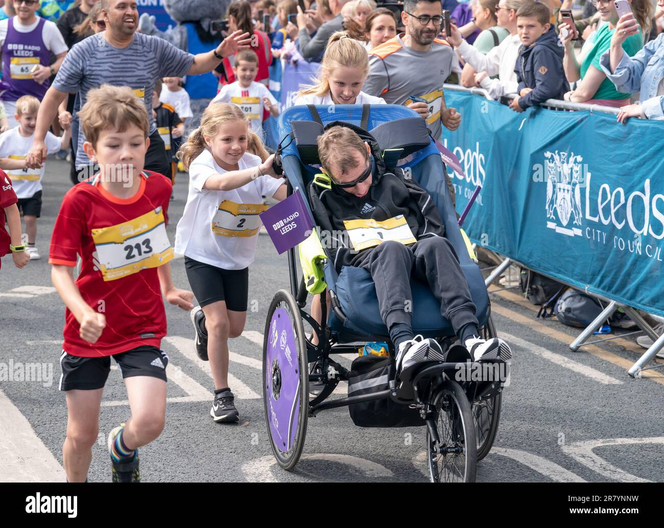 Rob Burrow is pushed by his daughters, Maya (left), 8, and Macy (right ...