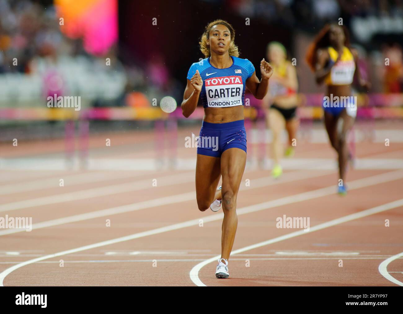 Kori Carter participating in the 400 meters hurdles at the World ...