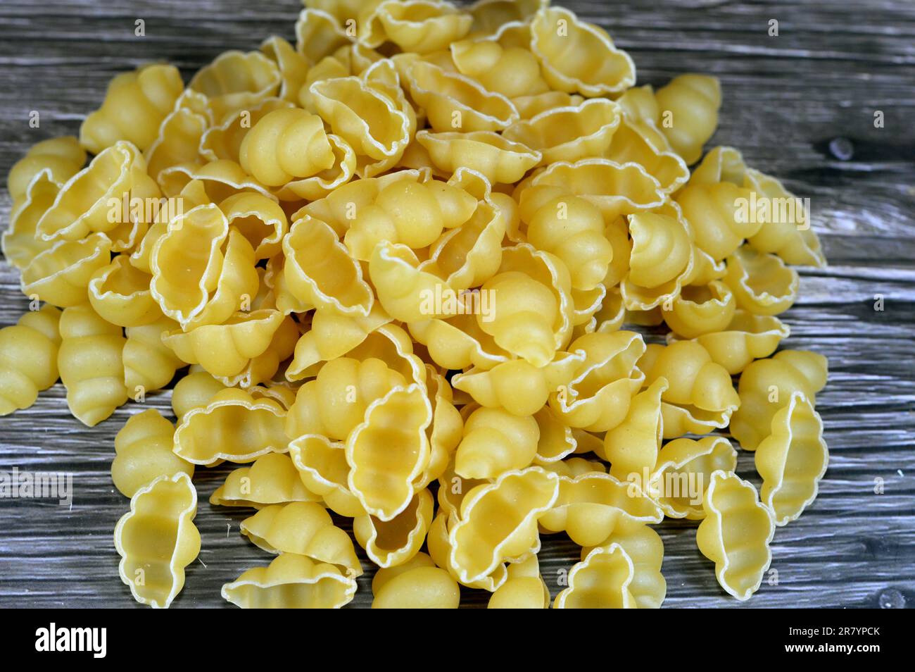 Pile of dry raw uncooked Macaroni, dry pasta shaped like snails, Made ...