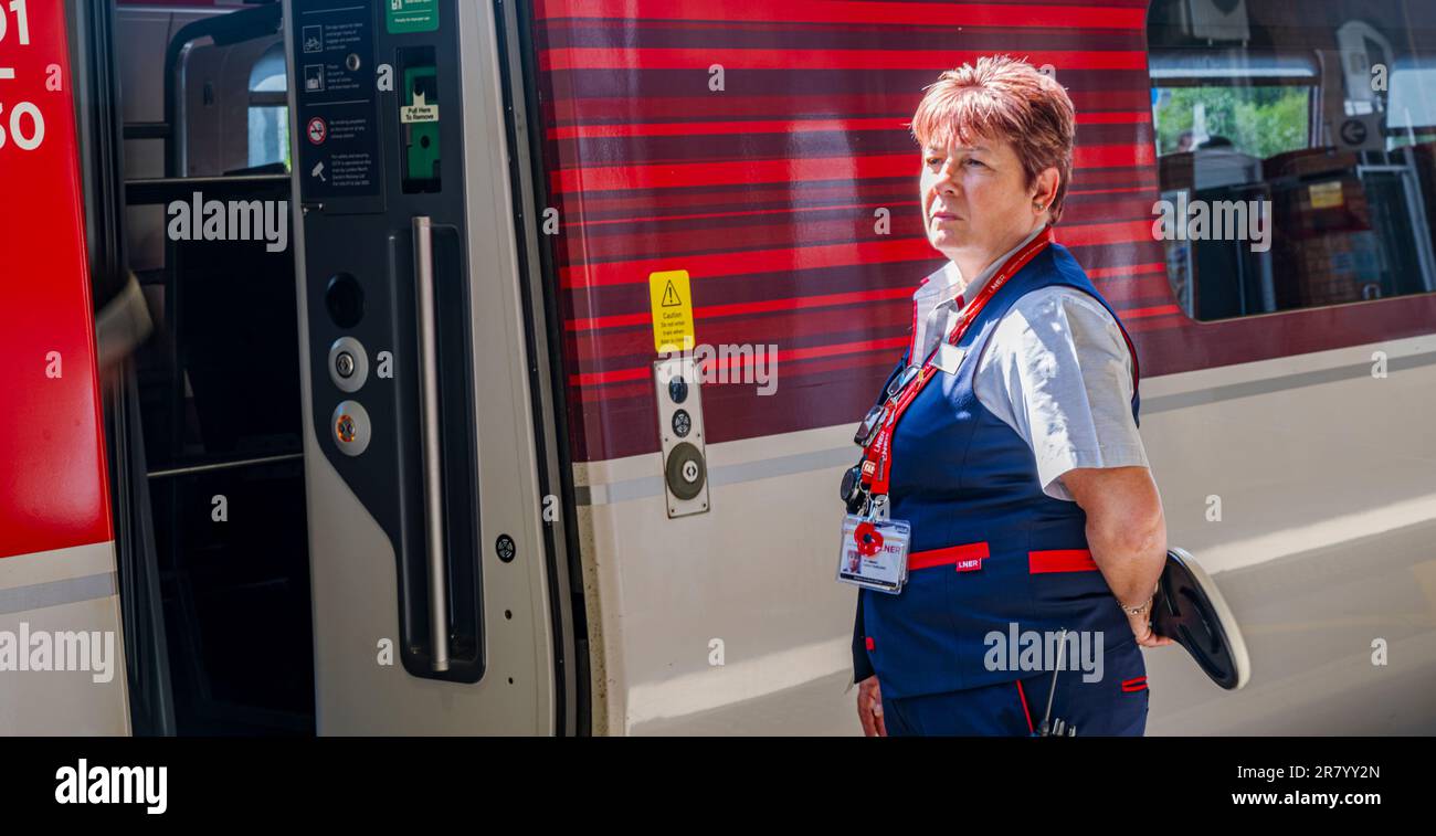 Grantham Train Station – A female conductor or guard despatching a ...