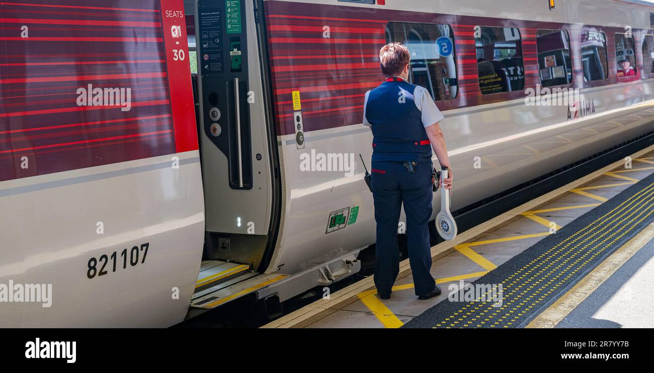 Grantham Train Station – A female conductor or guard despatching a ...