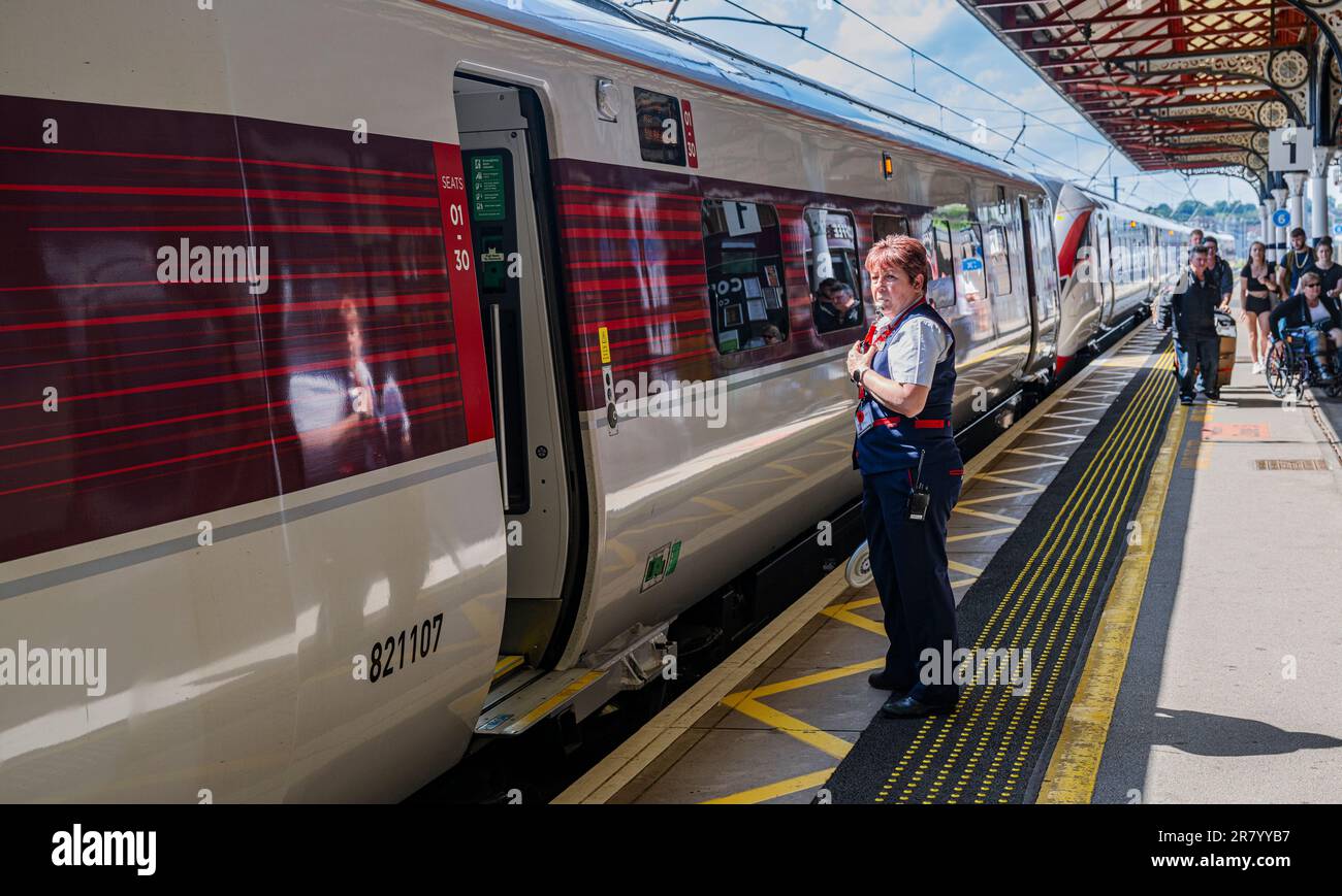 Grantham Train Station – A female conductor or guard despatching a ...