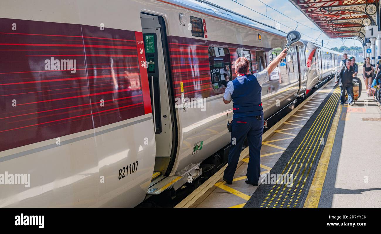Grantham Train Station – A female conductor or guard despatching a ...