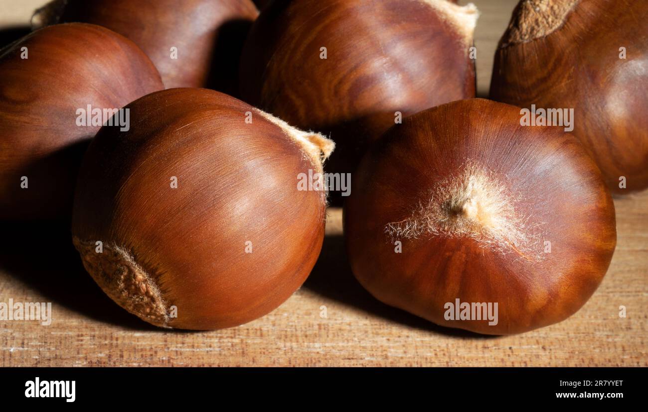 Holiday chestnuts ready to roast sitting on burtcher block Stock Photo ...