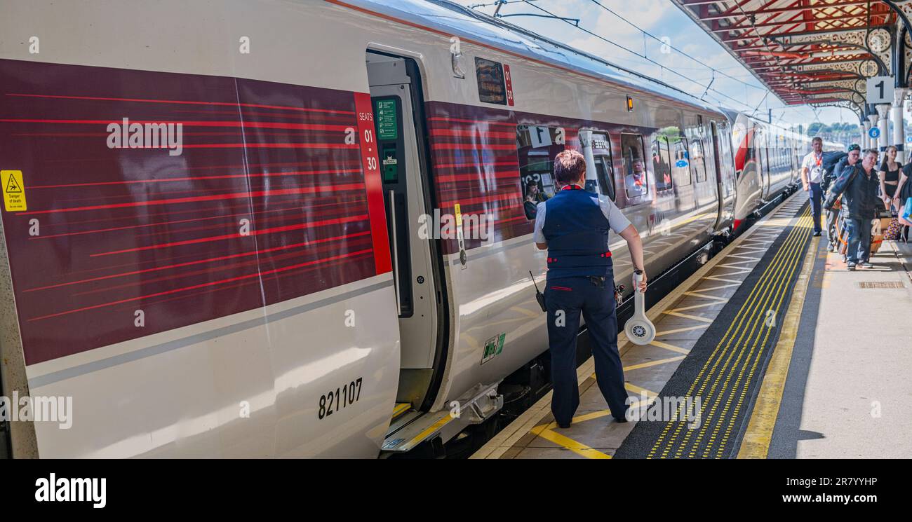 Grantham Train Station – A female conductor or guard despatching a ...
