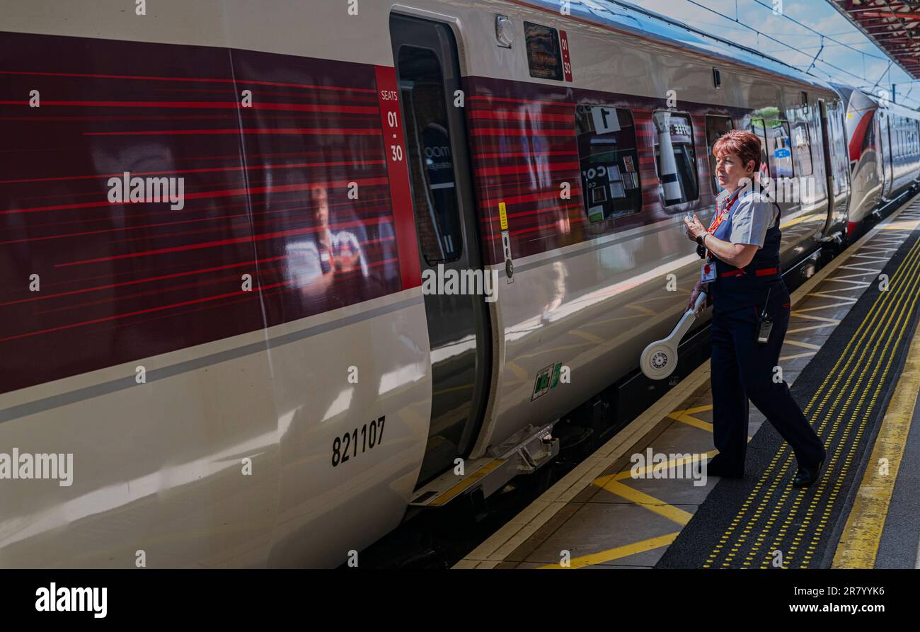 Grantham Train Station – A female conductor or guard despatching a ...