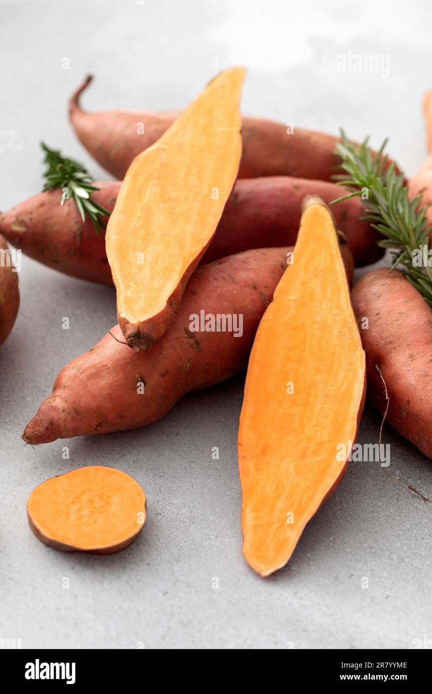 Raw sweet potatoes whole and cut. Orange kumara, sweet potato ...