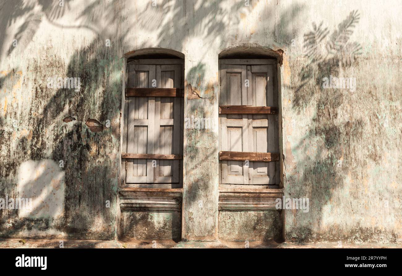 Old colonial style wall with closed windows in Yangon, Myanmar Stock ...