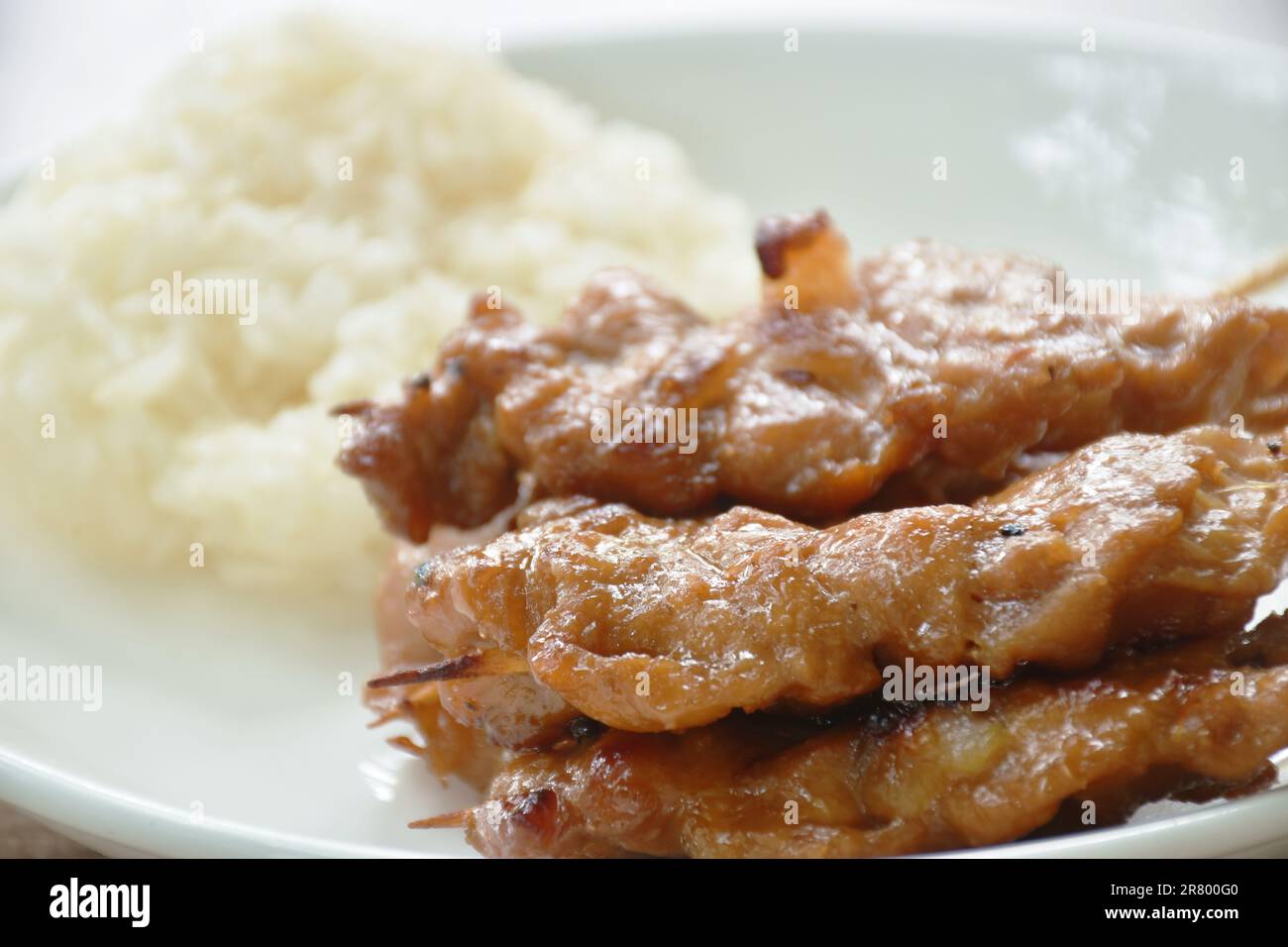 grilled pork in wooden stick eat with sticky rice on dish Stock Photo ...