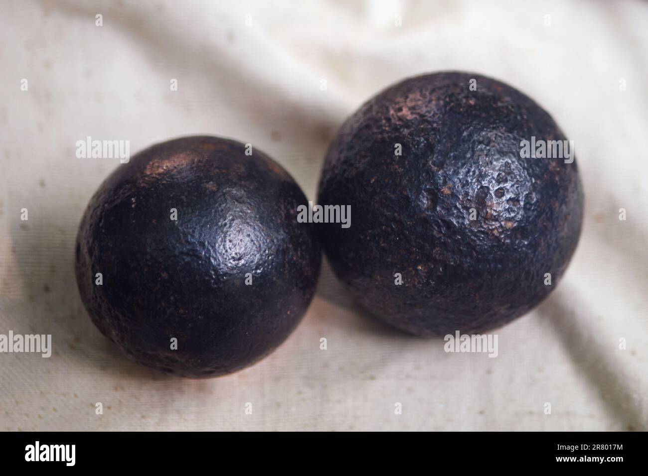 Two cannon ball one-pound closeup. Old objects of the 18th century era ...