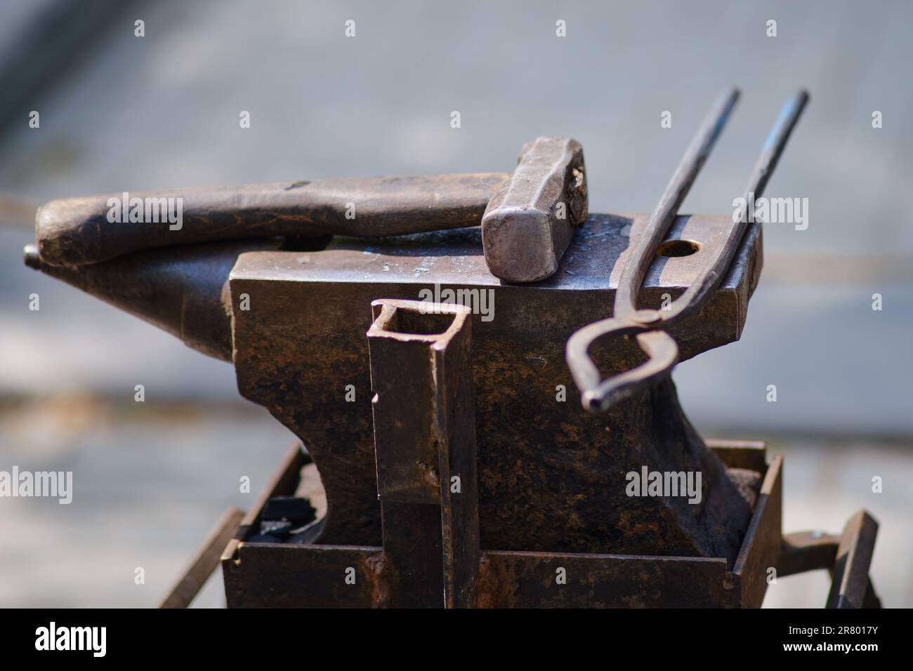 Hammer and tools for forging metal by a blacksmith. Blacksmithing in ...
