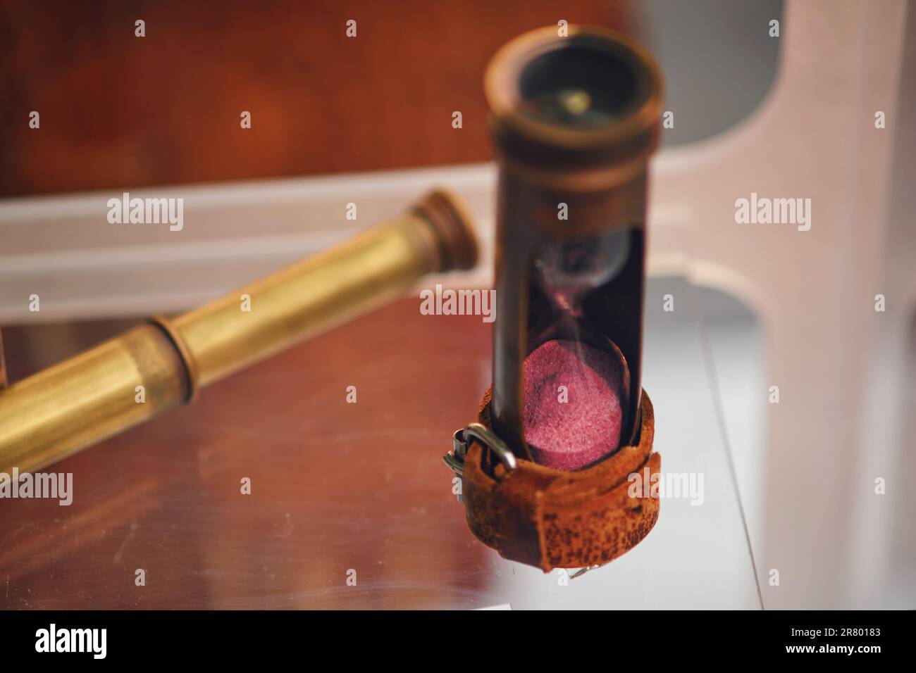 Antique hourglass and telescope for observation from the ship. Old ...