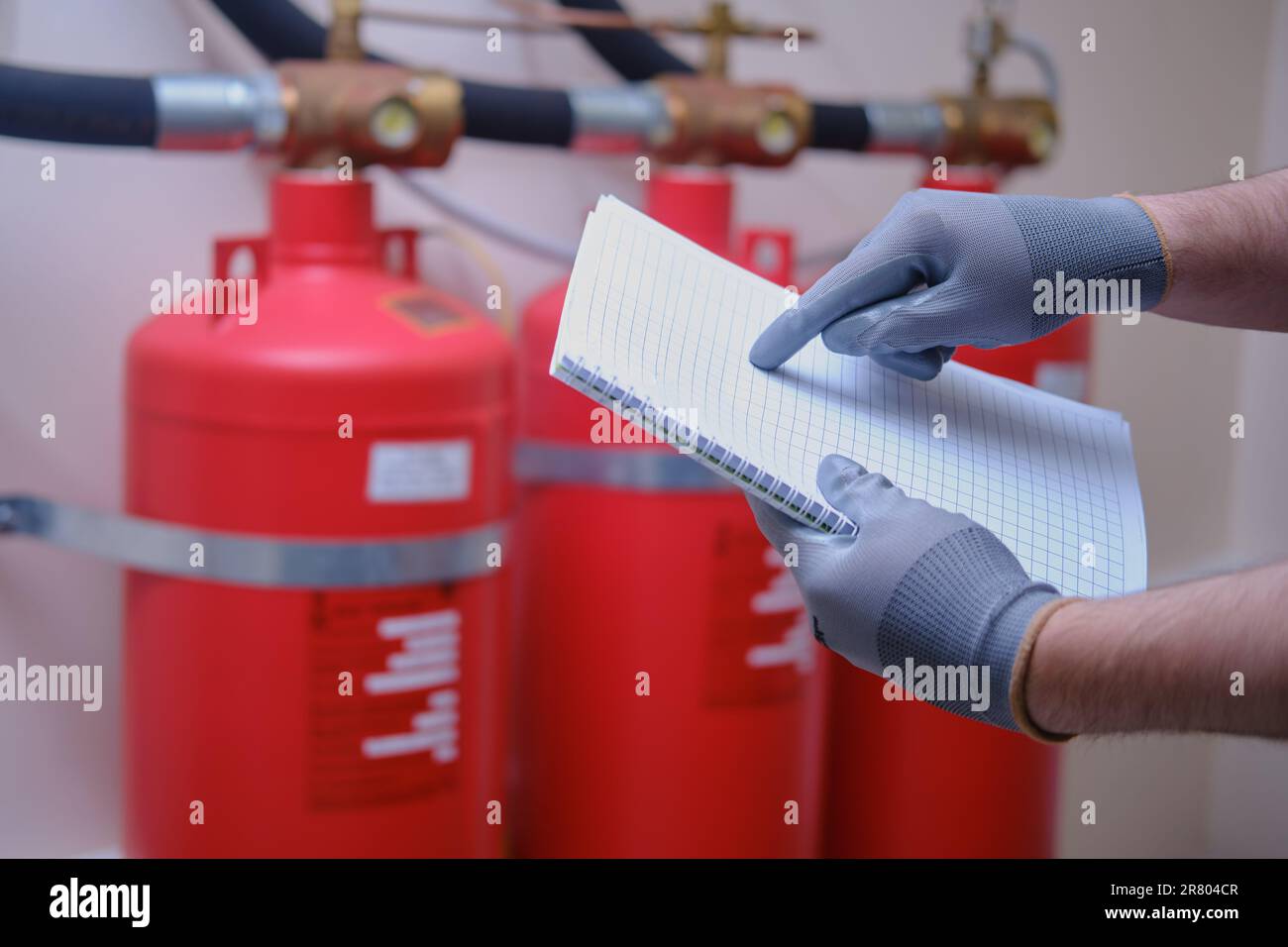 The inspector of fire security is using his notepad to jot down notes ...