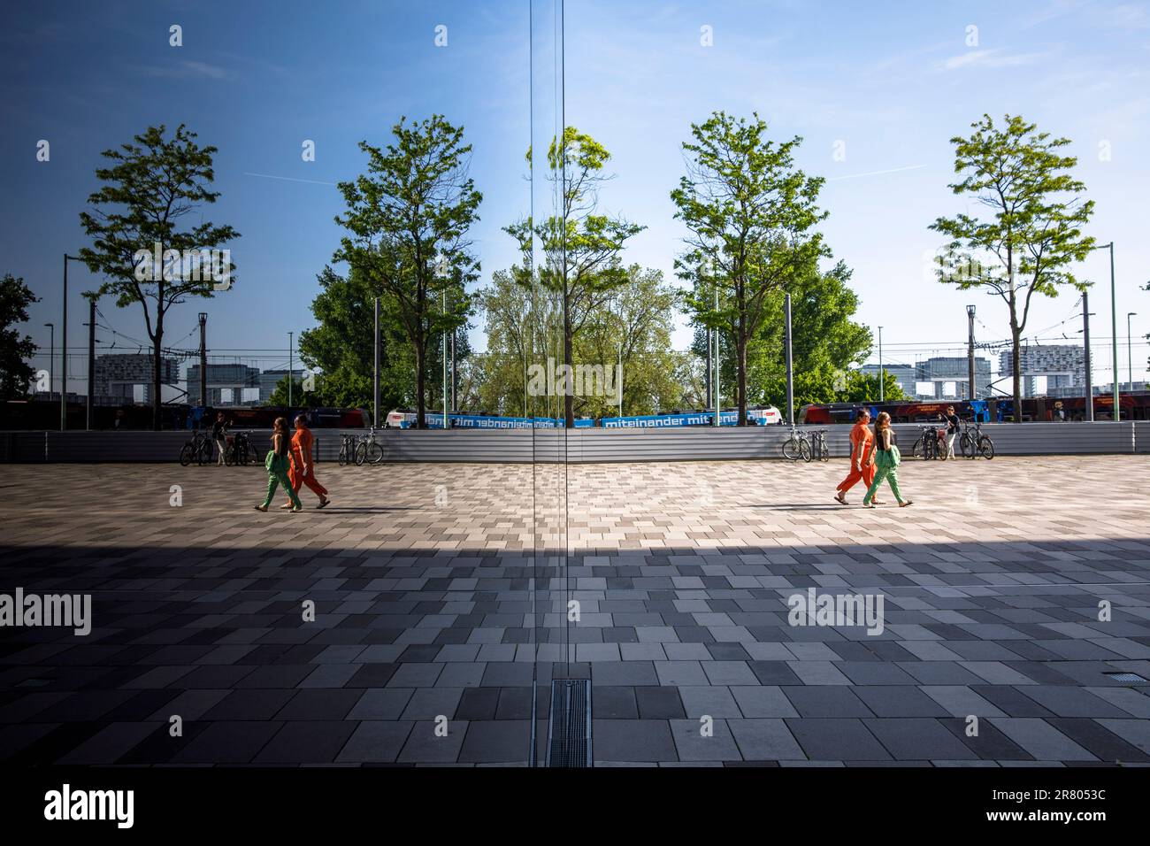 passers-by are reflected in the facade of the Lanxess Tower at ...
