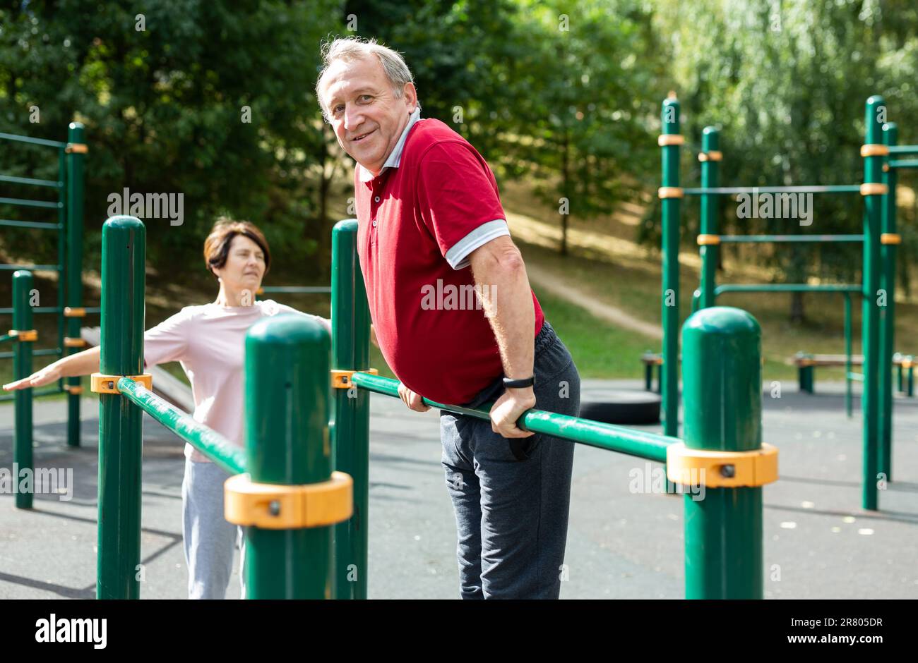 Senior man pulls up on crossbar in city park on sports ground Stock ...