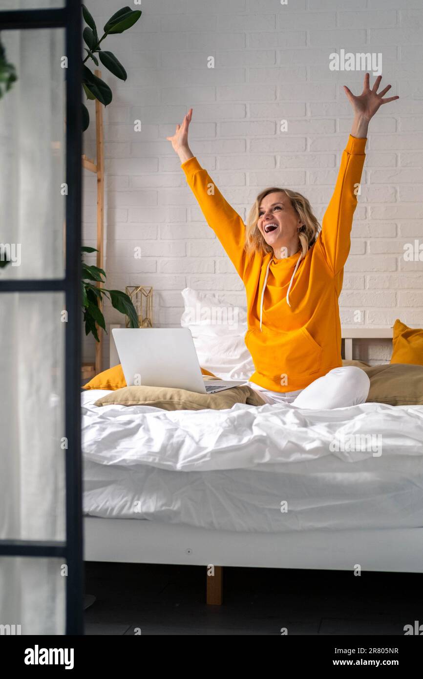 Excited overjoyed woman girl Using computer laptop working office work ...