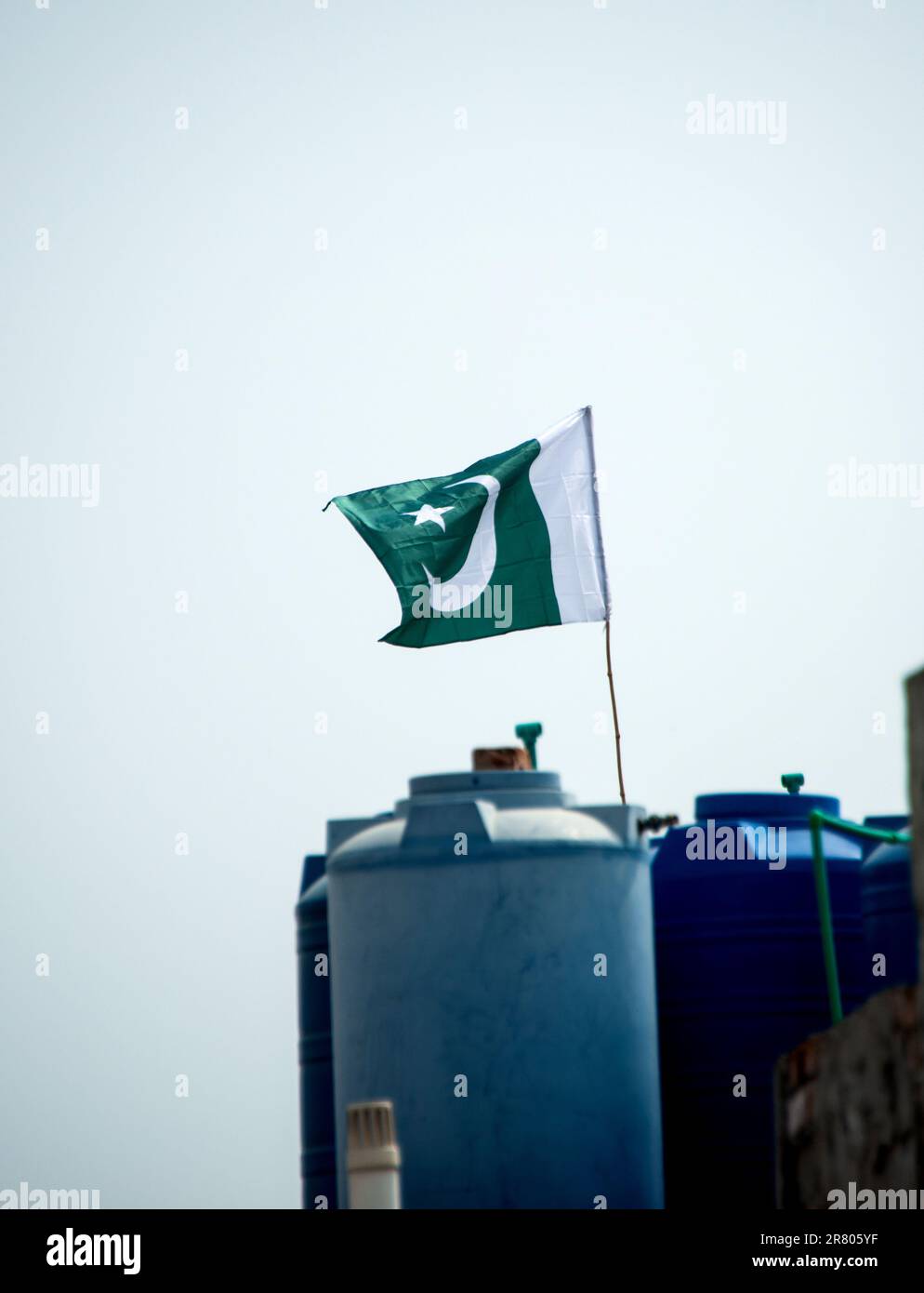 The national flag of Pakistan flying in the blue sky with clouds ...