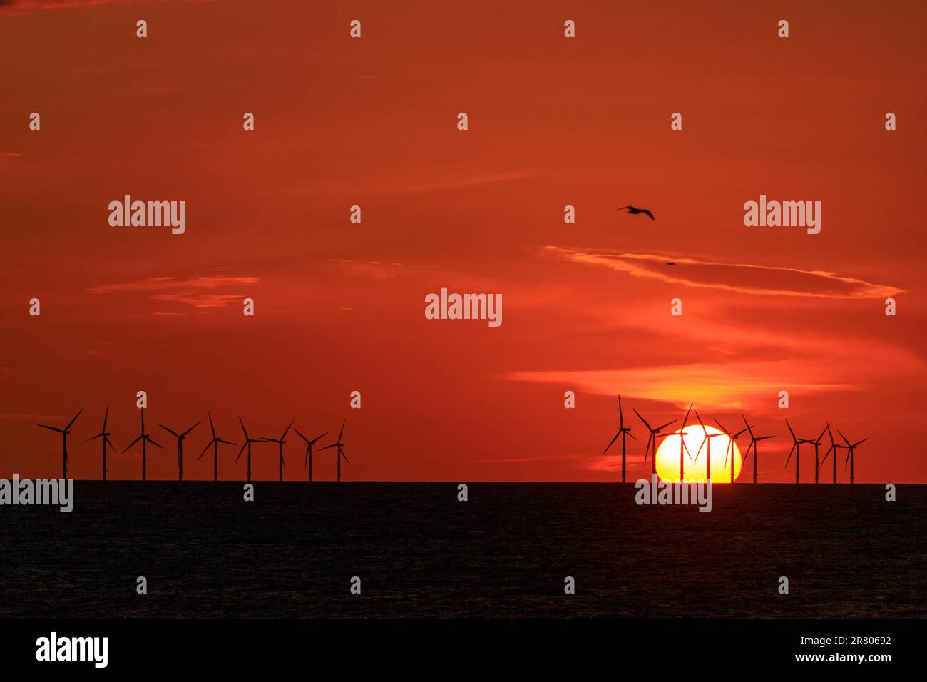 Sunset over offshore wind turbines on the north Wales coast Stock Photo ...