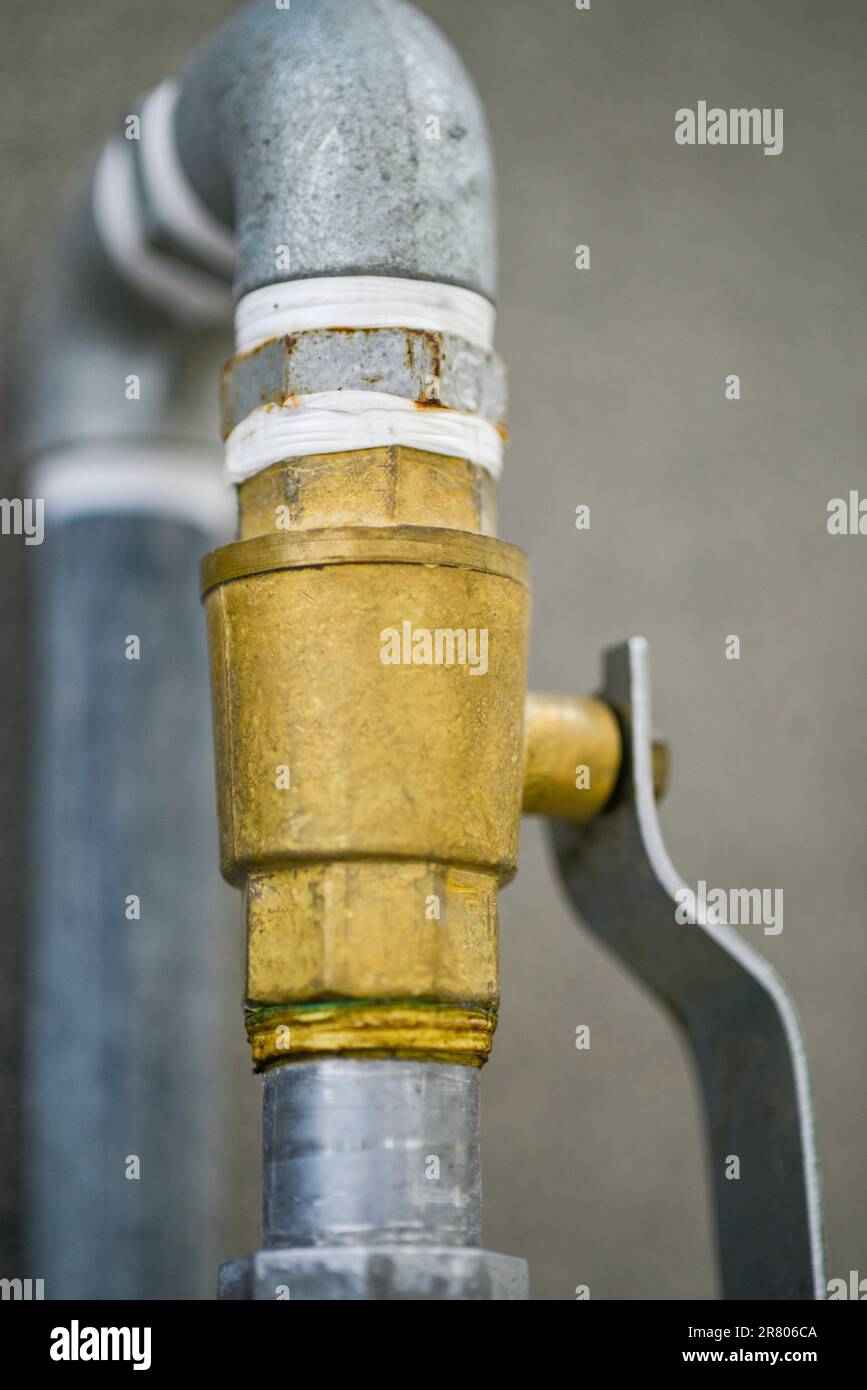 Metal gas valve control liver handled Stock Photo - Alamy