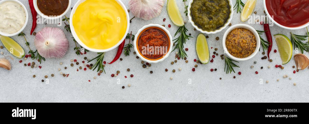 Different types of sauces in bowls with seasonings banner, rosemary and ...