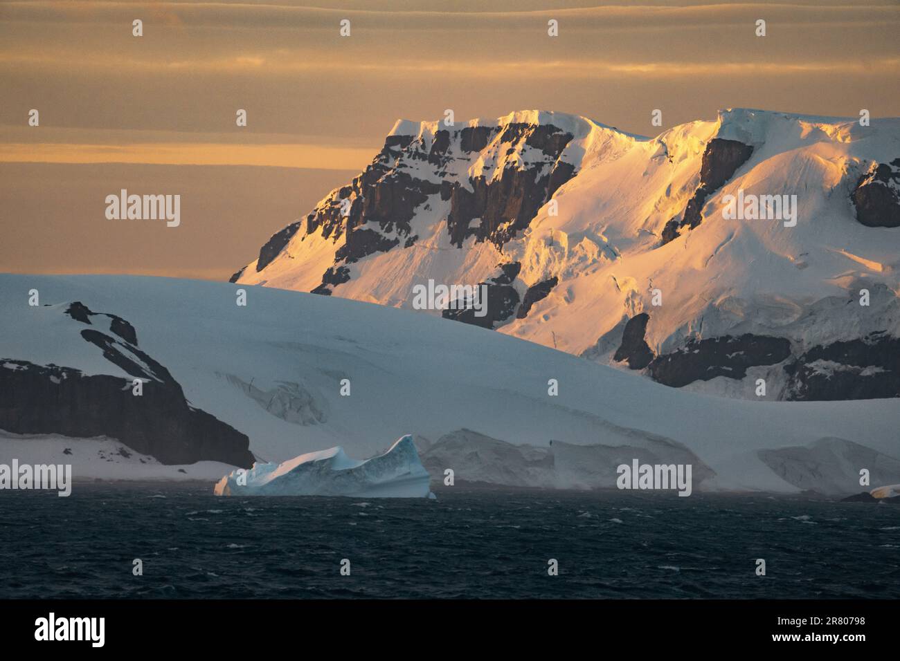 Beautiful iceberg floating in the water. Photo taken at sunset in ...