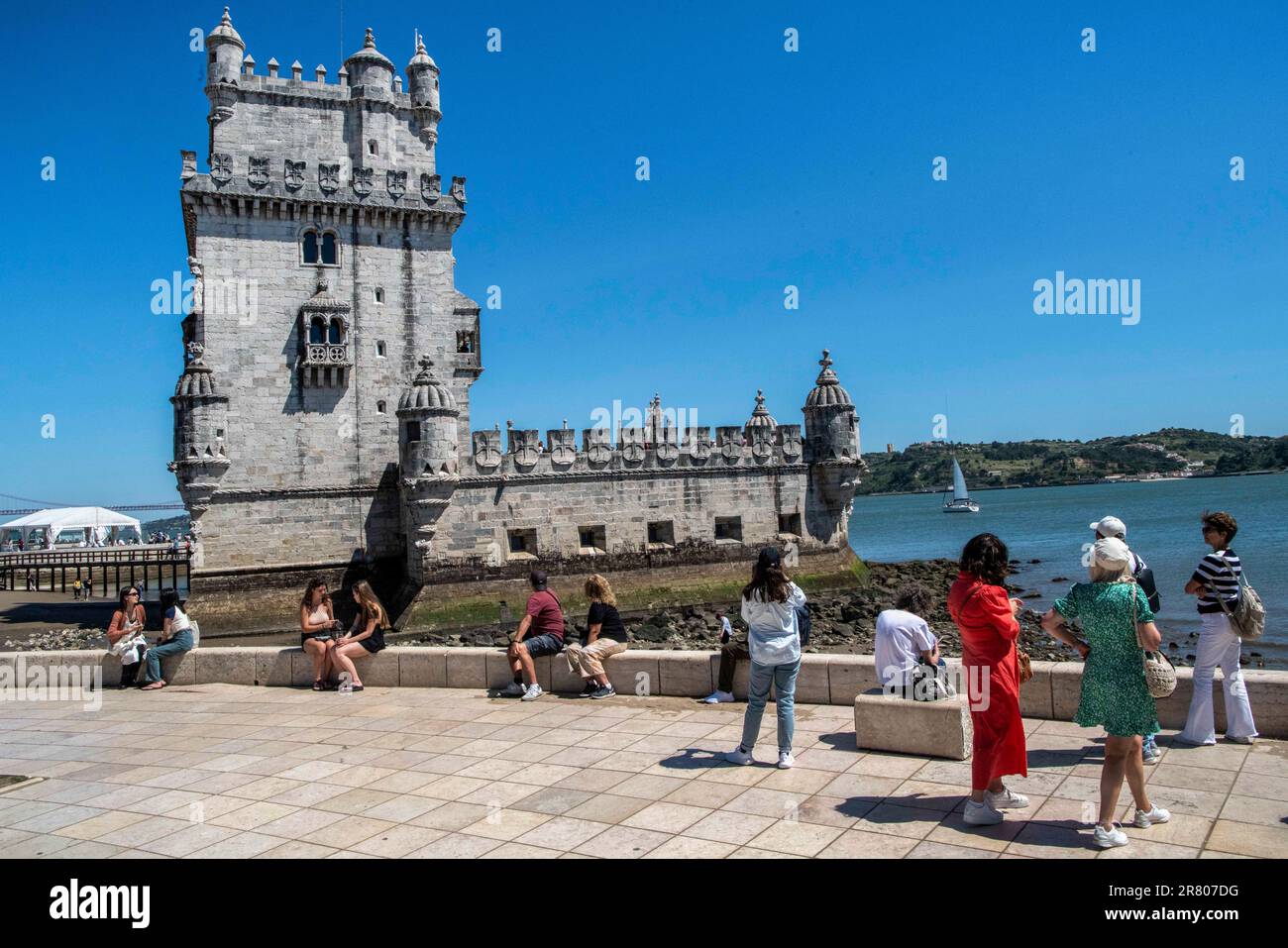 People are seen walking around the Belem Tower. This ancient military ...