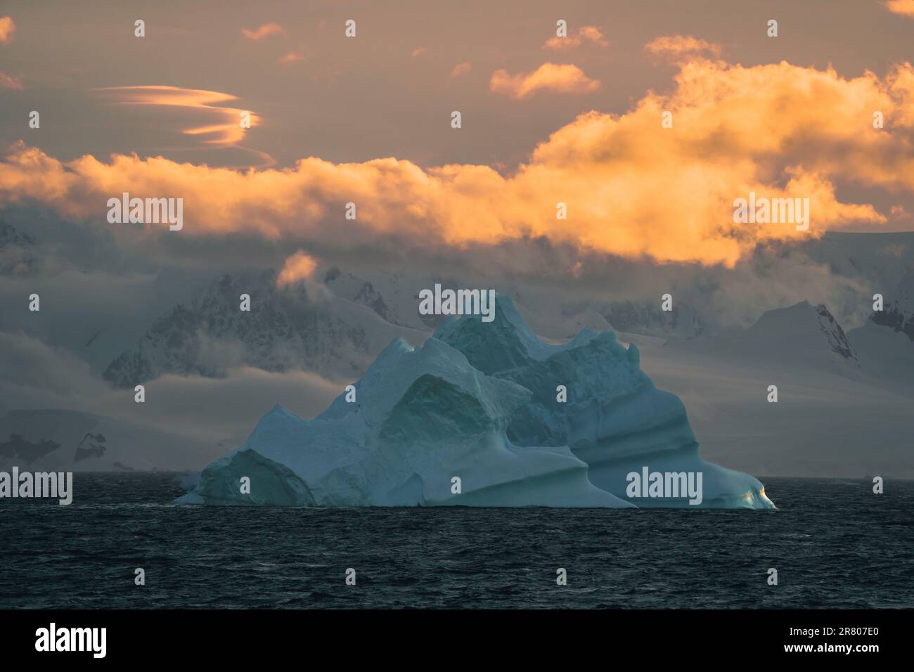 Beautiful iceberg floating in the water. Photo taken at sunset in ...