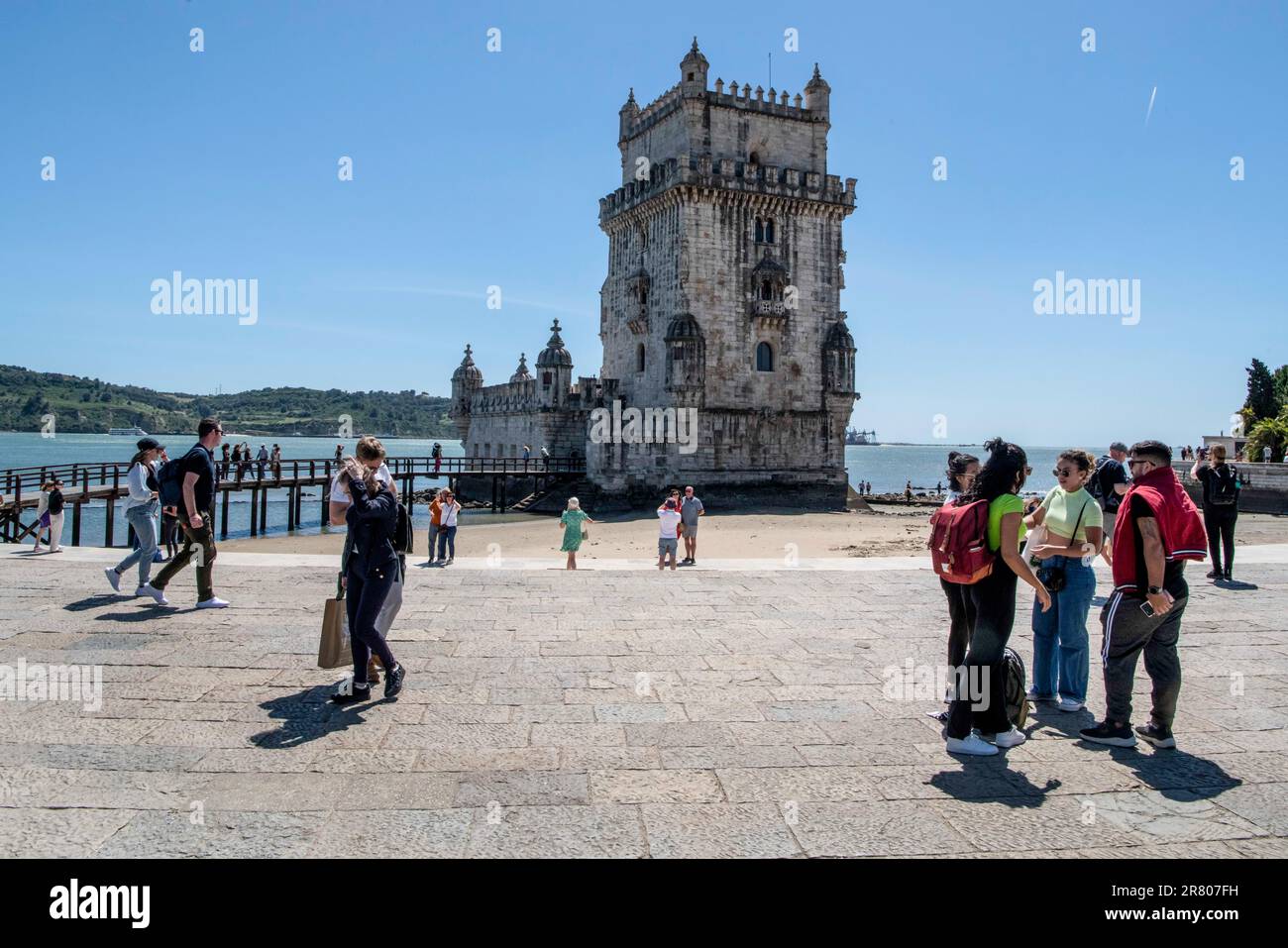 People are seen walking around the Belem Tower. This ancient military ...