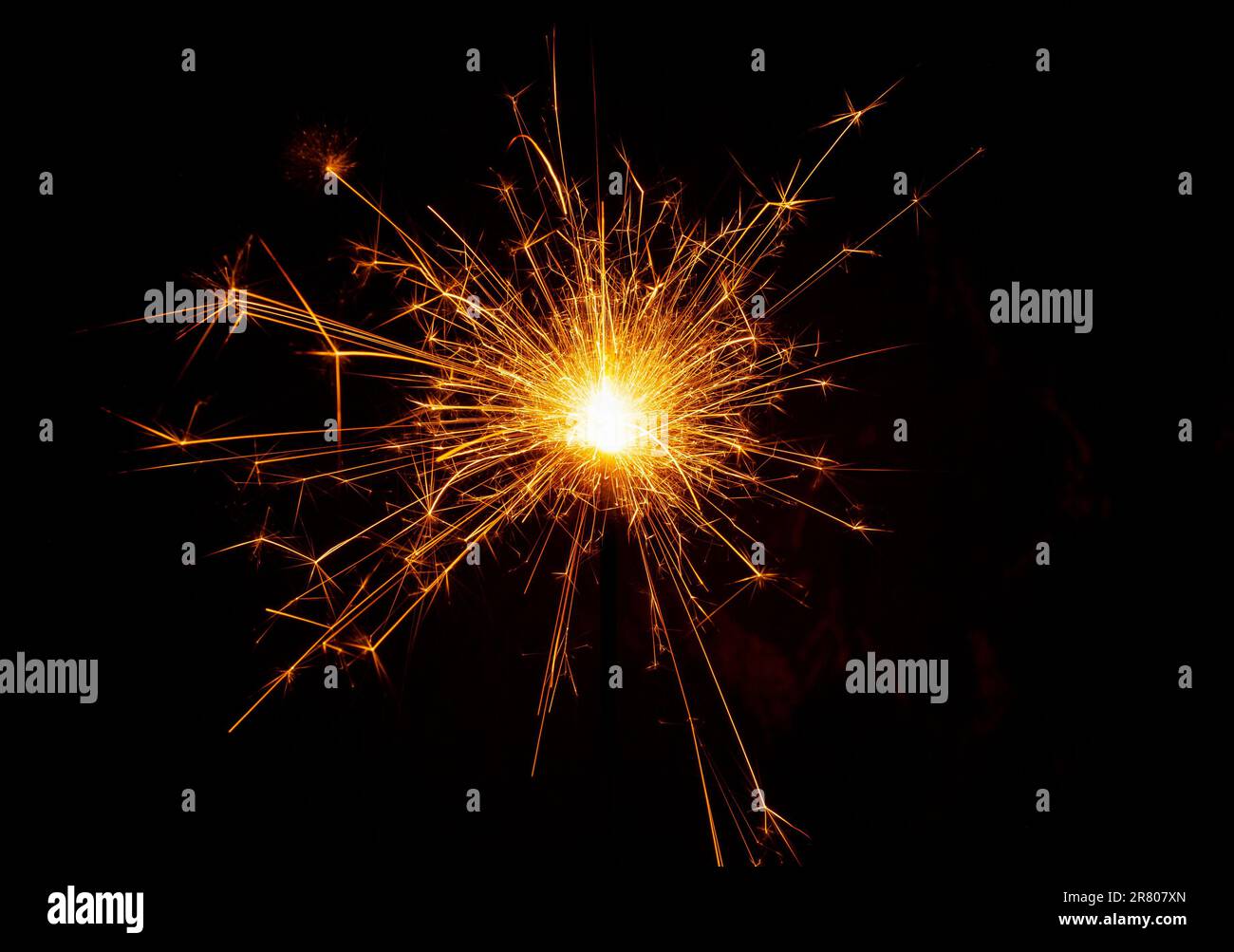 Bright burning sparkler on the dark background Stock Photo - Alamy