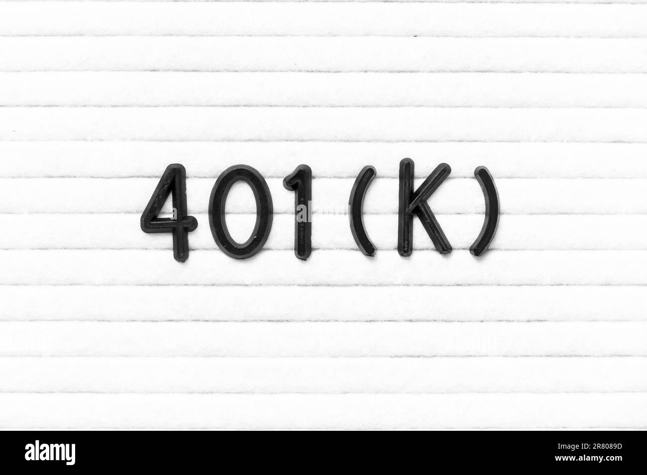 Black color letter in word 401(K) on white felt board background Stock ...