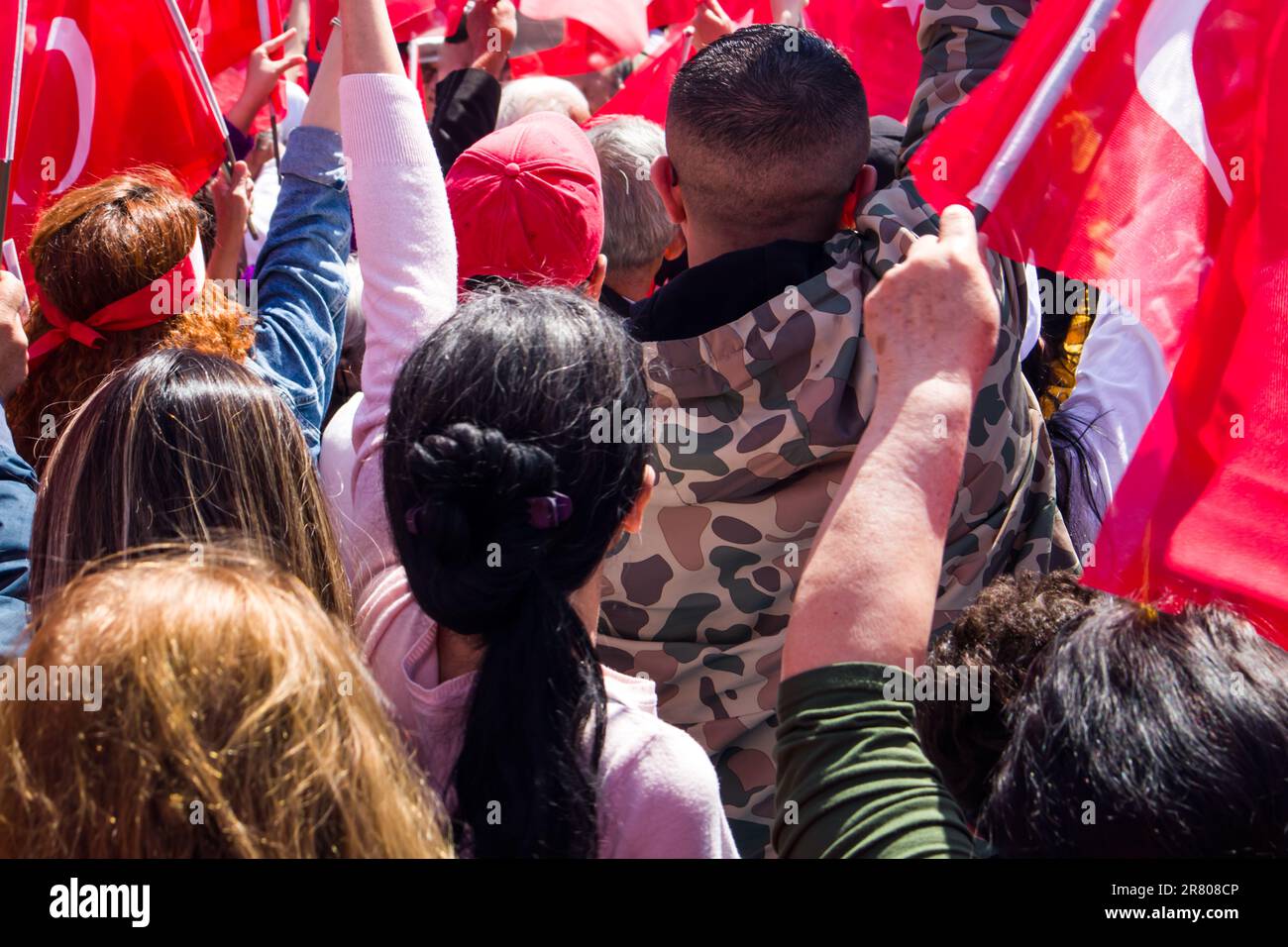 Unknown people, with their backs turned, hands up, at a celebration ...