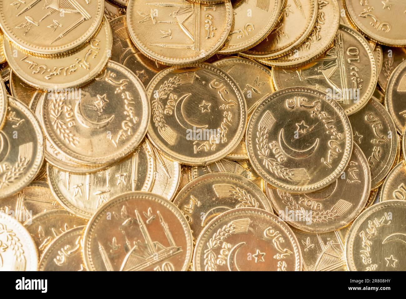 Stacks of gold coins of Pakistani currency symbolize wealth and ...