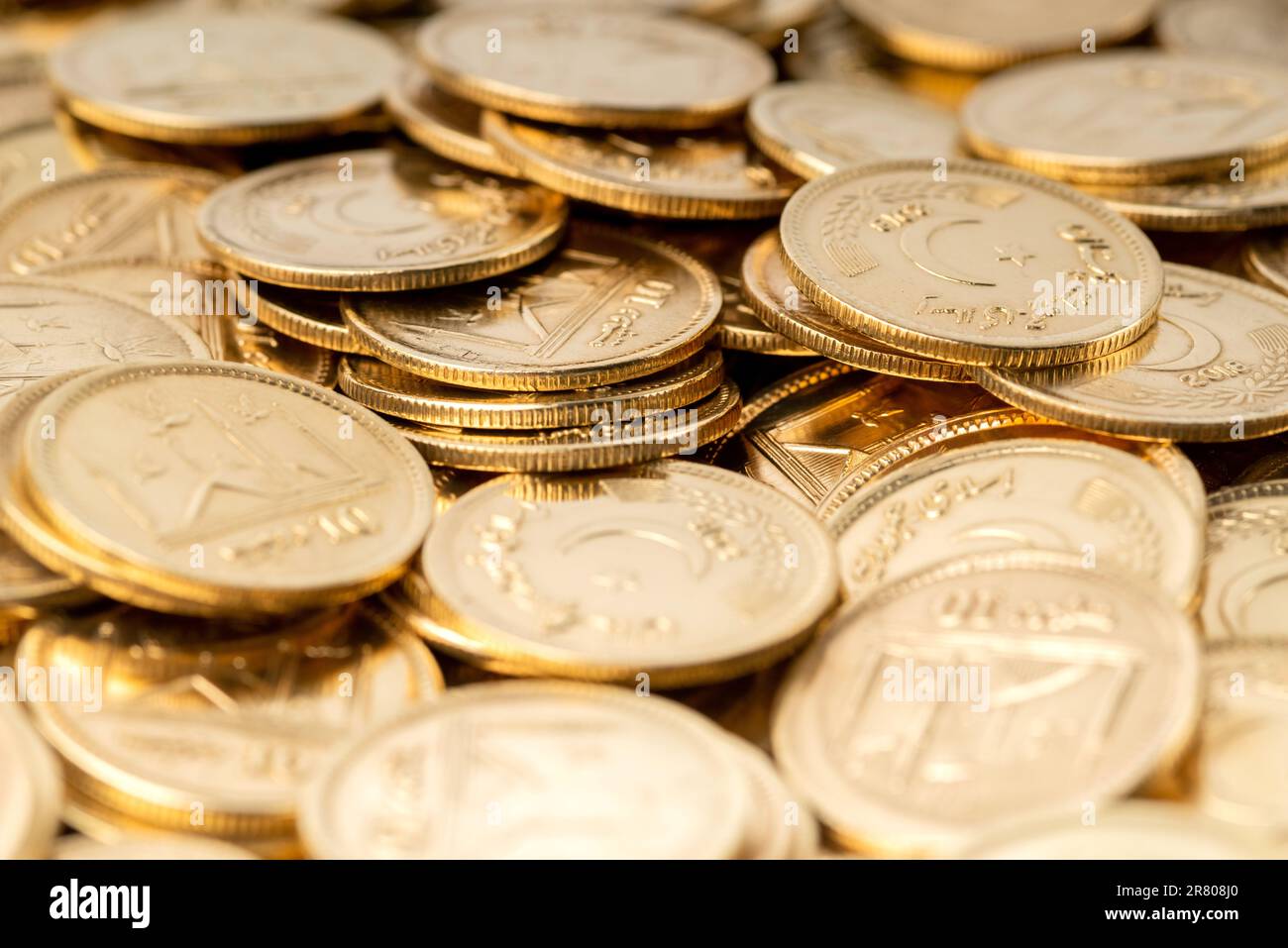 Stacks of gold coins of Pakistani currency symbolize wealth and ...