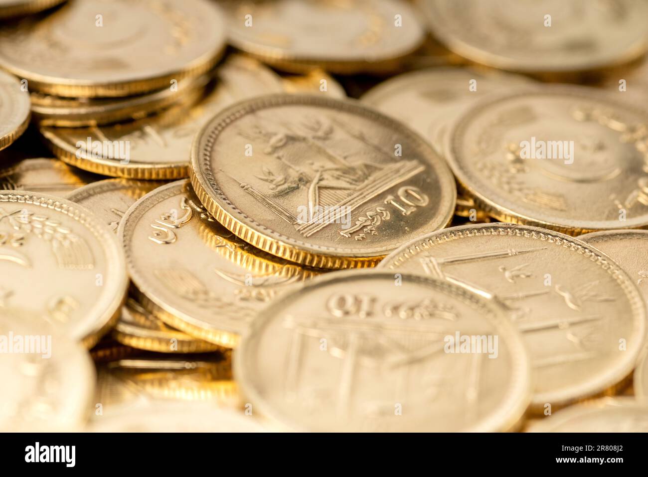 Stacks of gold coins of Pakistani currency symbolize wealth and ...