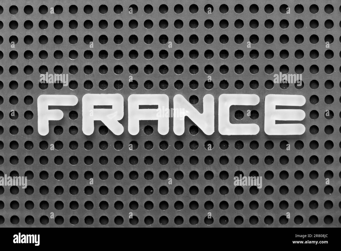 White alphabet letter in word france on black pegboard background Stock ...
