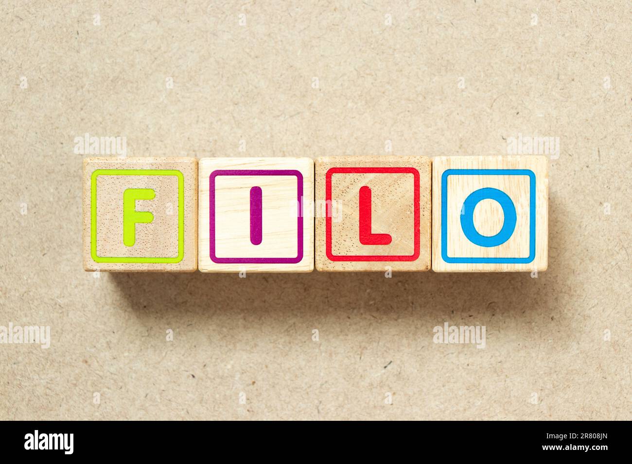 Wooden alphabet letter block in word FILO (abbreviation of first in ...