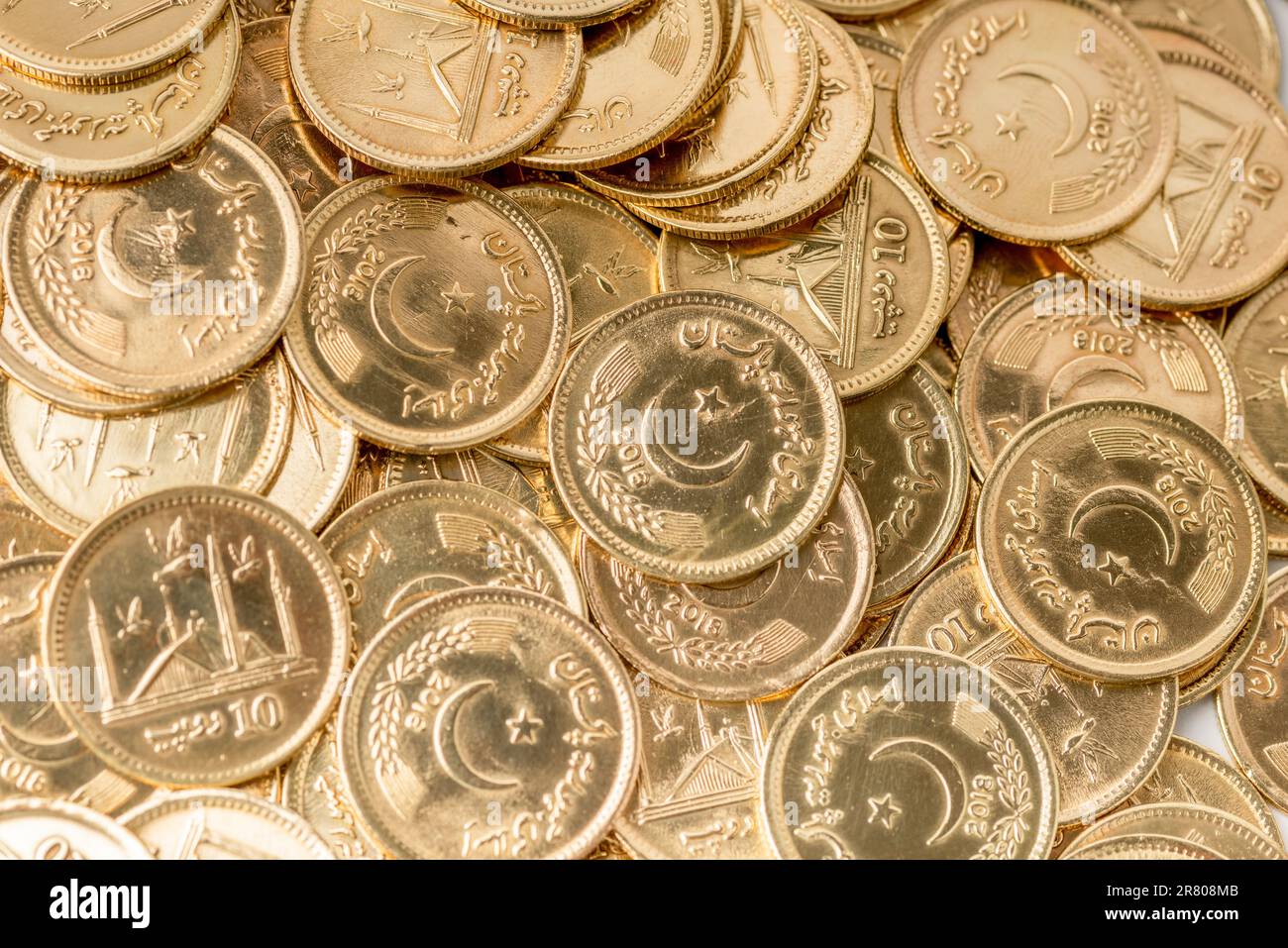 Stacks of gold coins of Pakistani currency symbolize wealth and ...