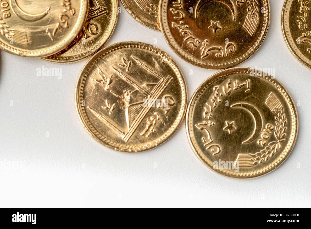 Stacks of gold coins of Pakistani currency symbolize wealth and ...