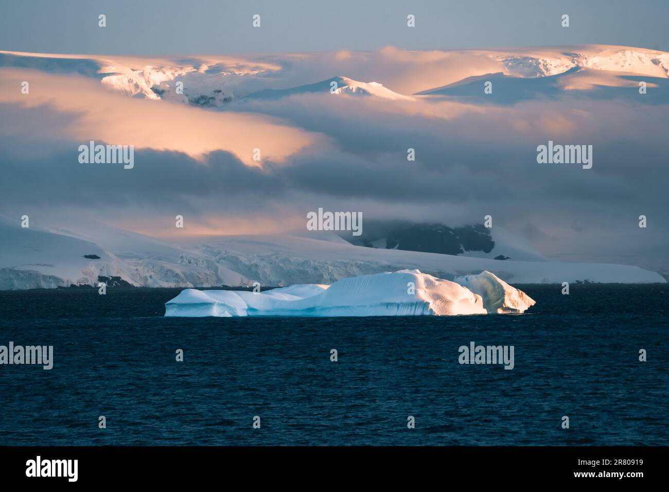 Beautiful iceberg floating in the water. Photo taken at sunset in ...