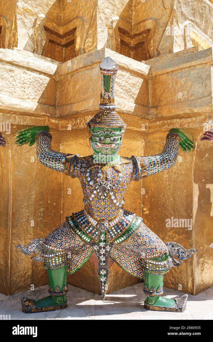 A mannequin in a detailed costume posing in front of a luxurious gold ...
