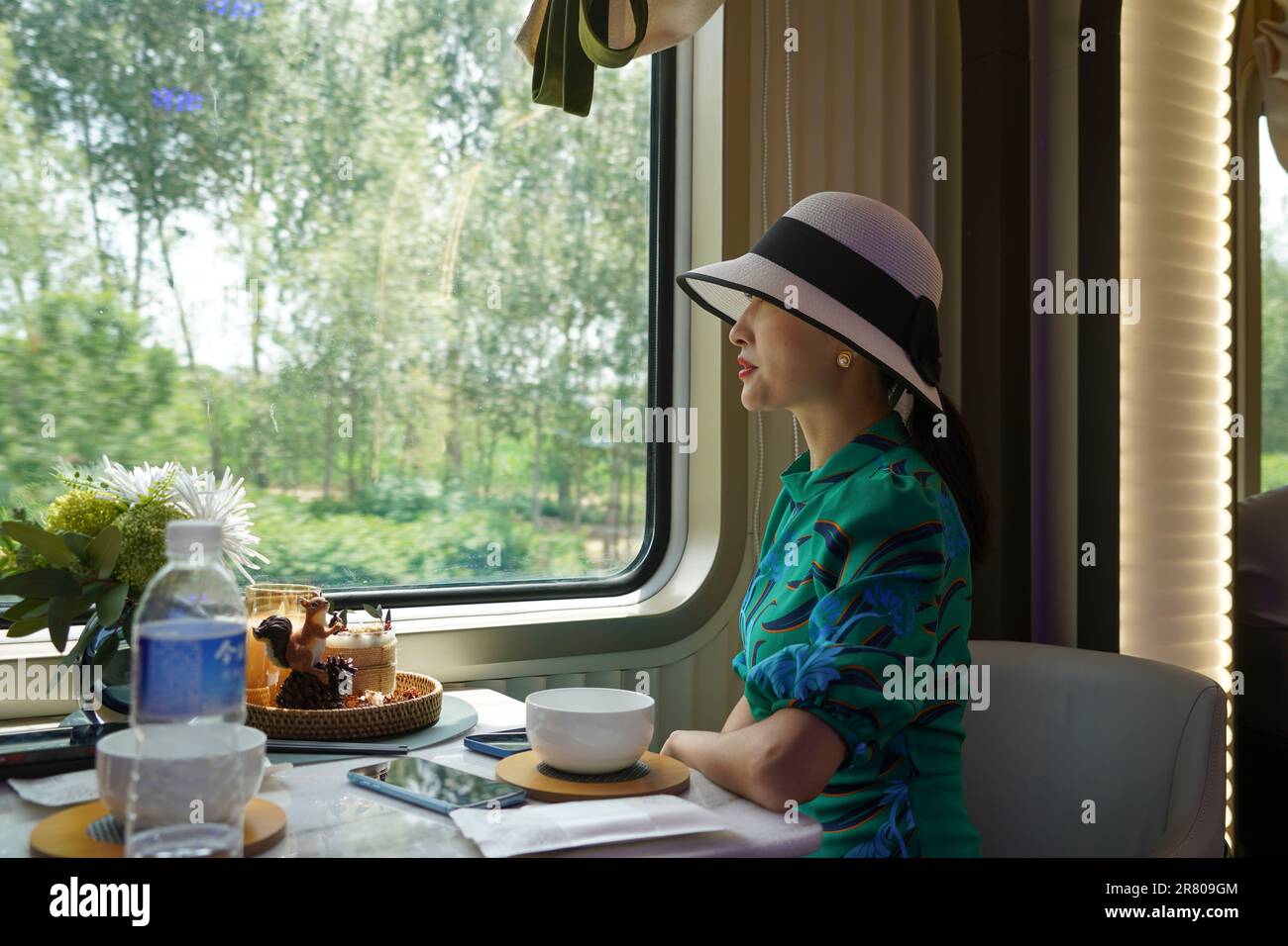 Harbin. 18th June, 2023. A passenger waits to have a meal aboard a ...