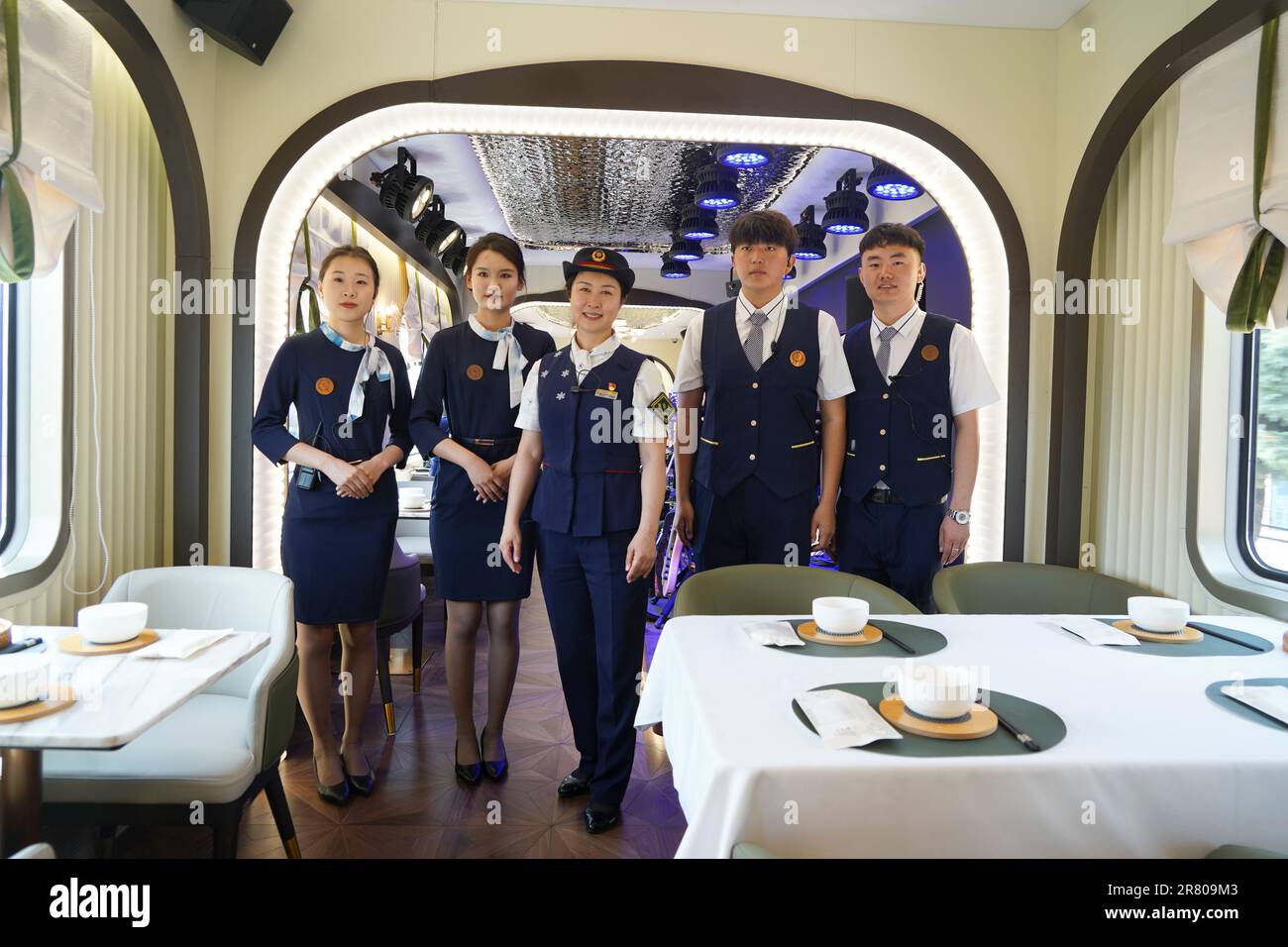 Harbin. 18th June, 2023. Train attendants pose for a photo aboard a ...
