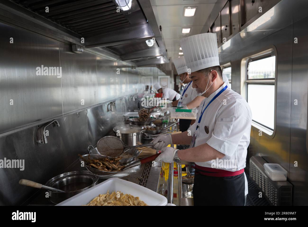 Harbin. 18th June, 2023. Chefs cook meals aboard a tourist train in ...