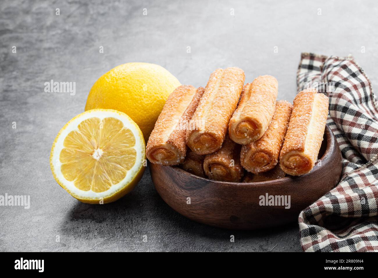 Homemade lemon jam filled sticks in wooden bowl on gray background ...