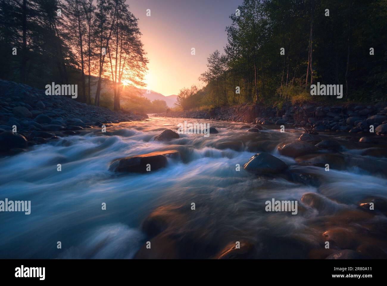Beautiful fast river flows in mountain forest at sunrise Stock Photo ...